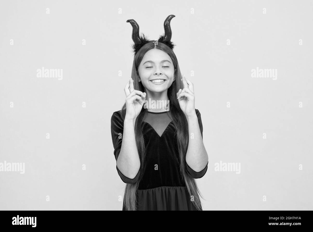 happy kid wear devil horns costume on halloween party making a wish ...