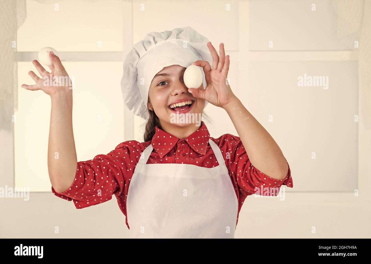 cheerful child girl cooking home pastry, egg Stock Photo - Alamy