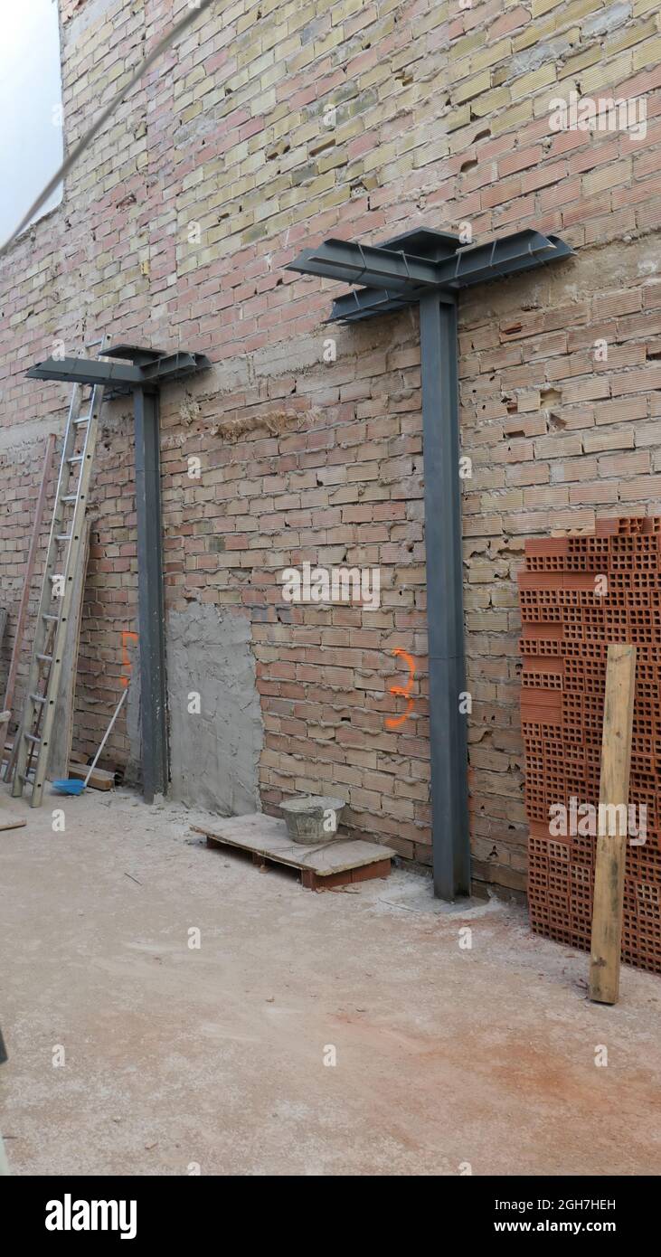 Heavy duty steel supports attached to wall at town centre building site ...