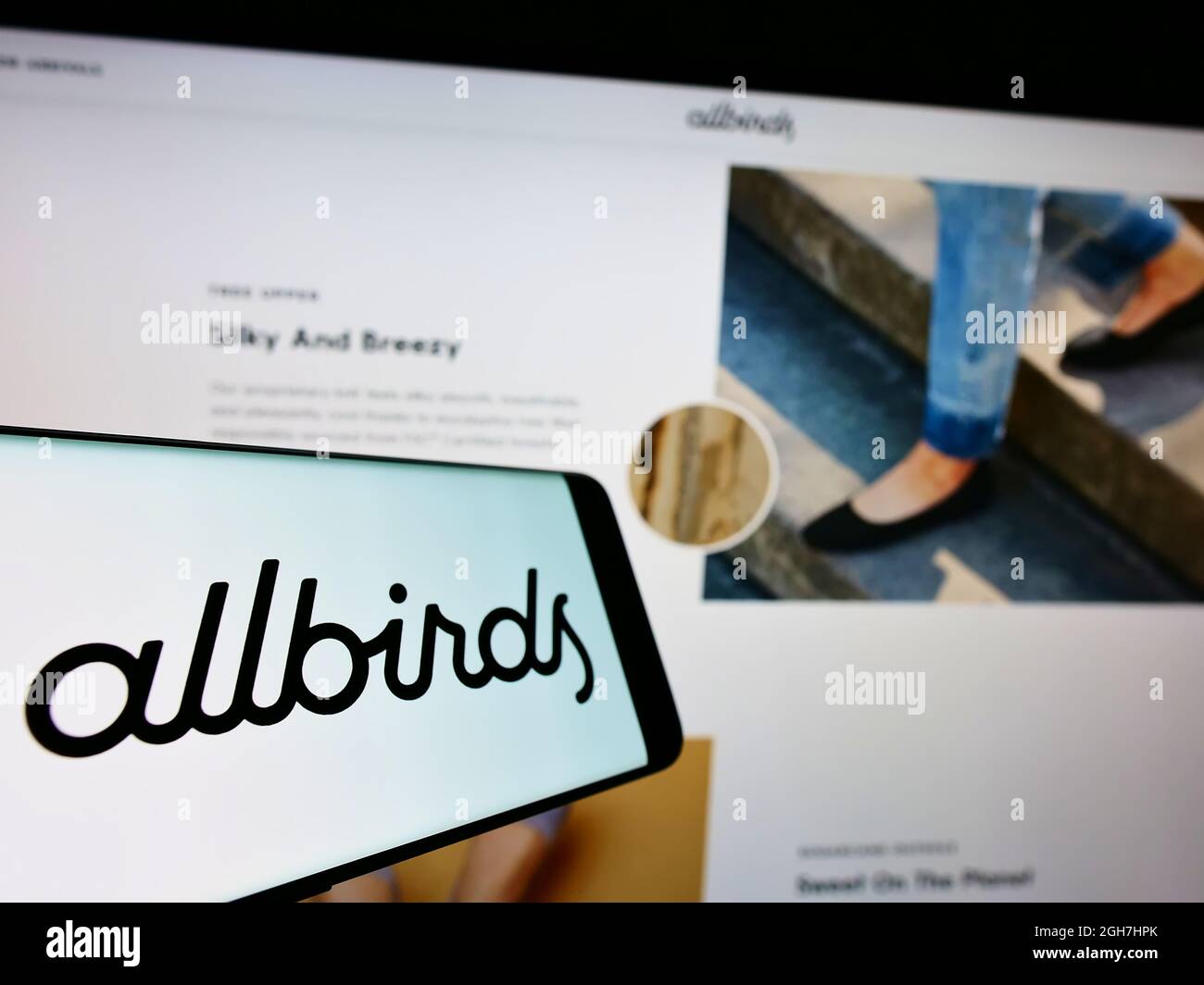 Smartphone with logo of footwear company Allbirds Inc. on screen in ...