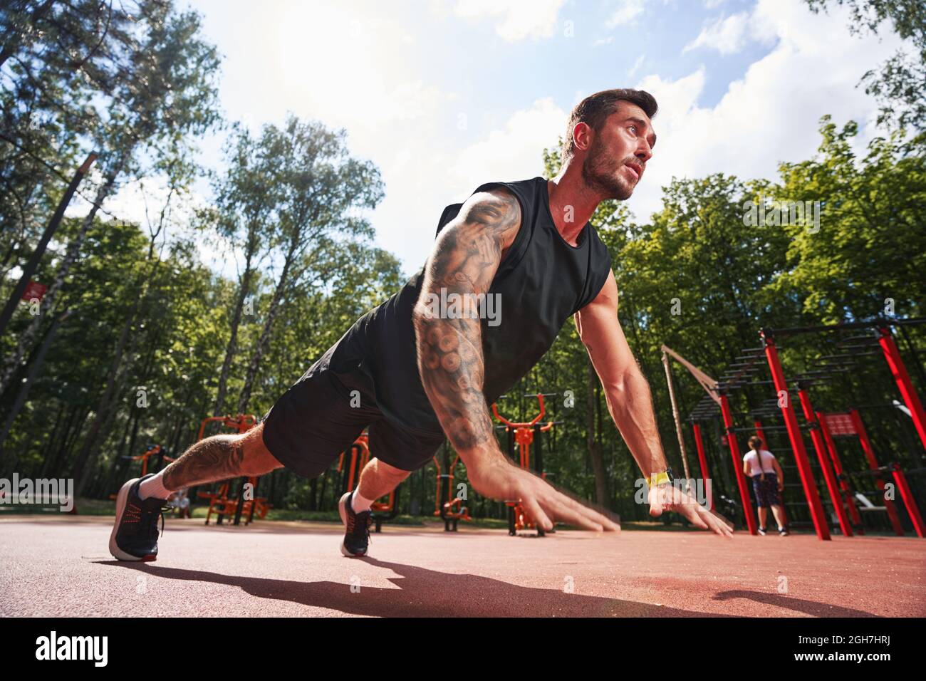Handsome bodybuilder doing core workout on sportsground Stock Photo - Alamy