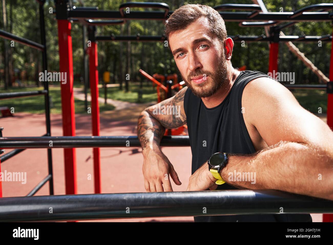 Relaxed young muscular man training on sportsground Stock Photo - Alamy
