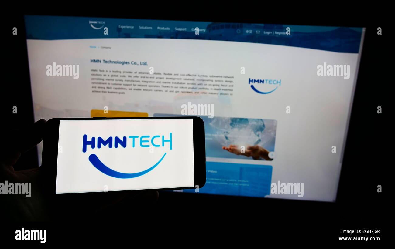 Person holding mobile phone with logo of Chinese submarine network ...