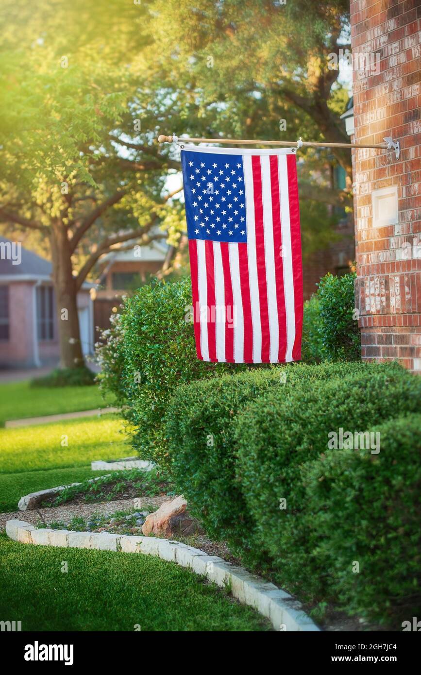 American flag flying at half-staff of a residential home Stock Photo ...