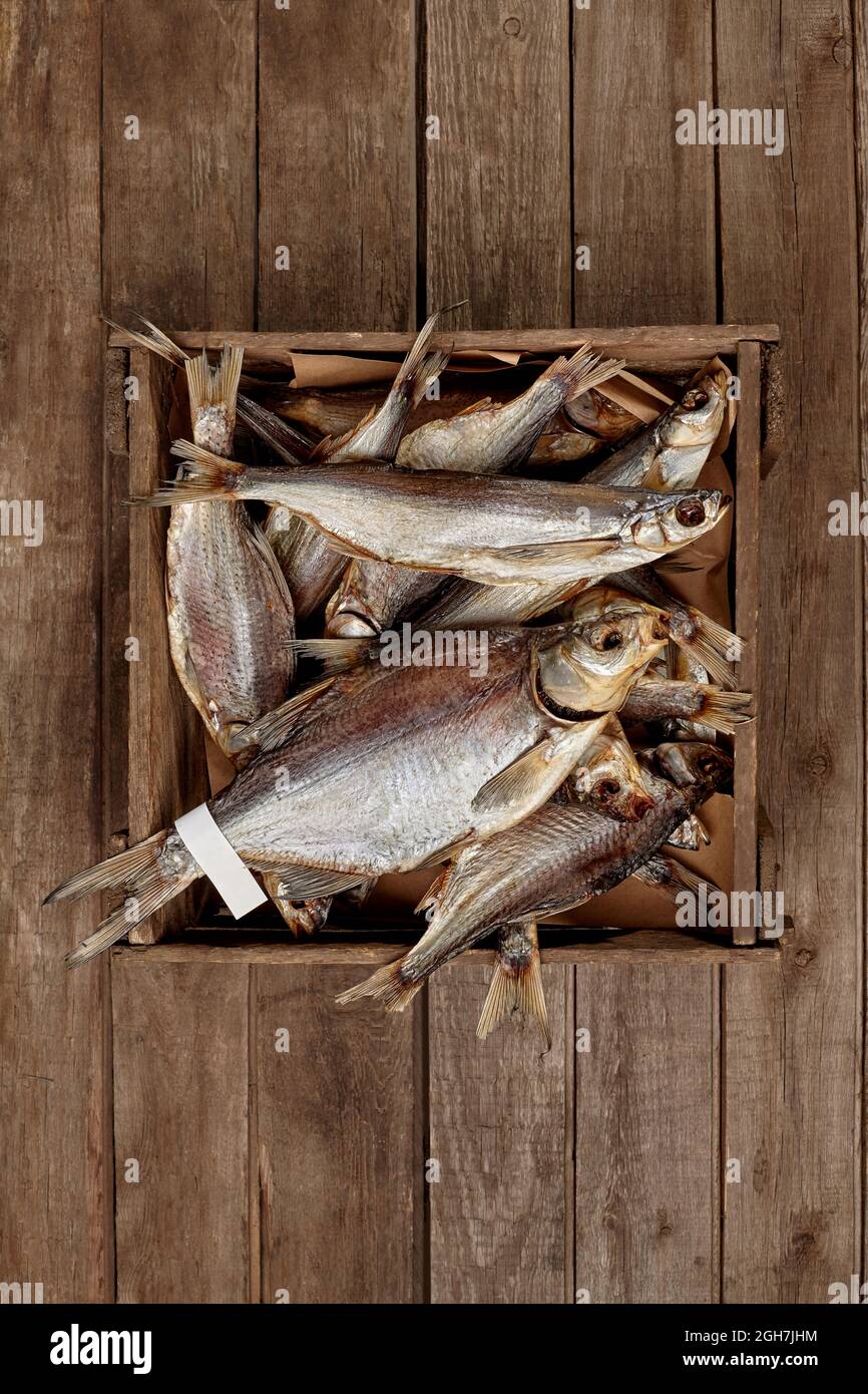 Crate with various sun-dried fish on wooden planks background Stock ...