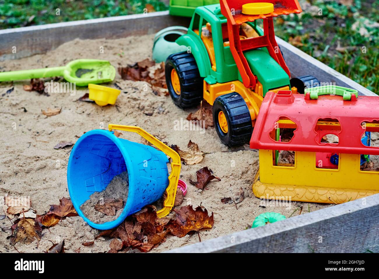 Forgotten toys in the sandbox outside. Children playground outdoors ...