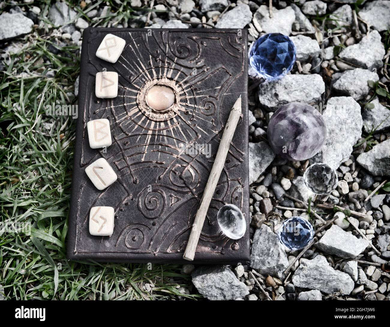 Grunge still life with witch book of magic spells, runes and crystals ...