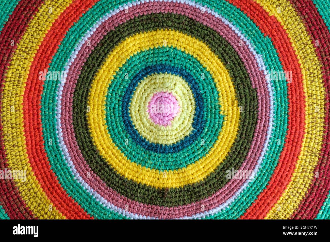 handmade round multicolor cotton knitted rug, top view, directly above ...