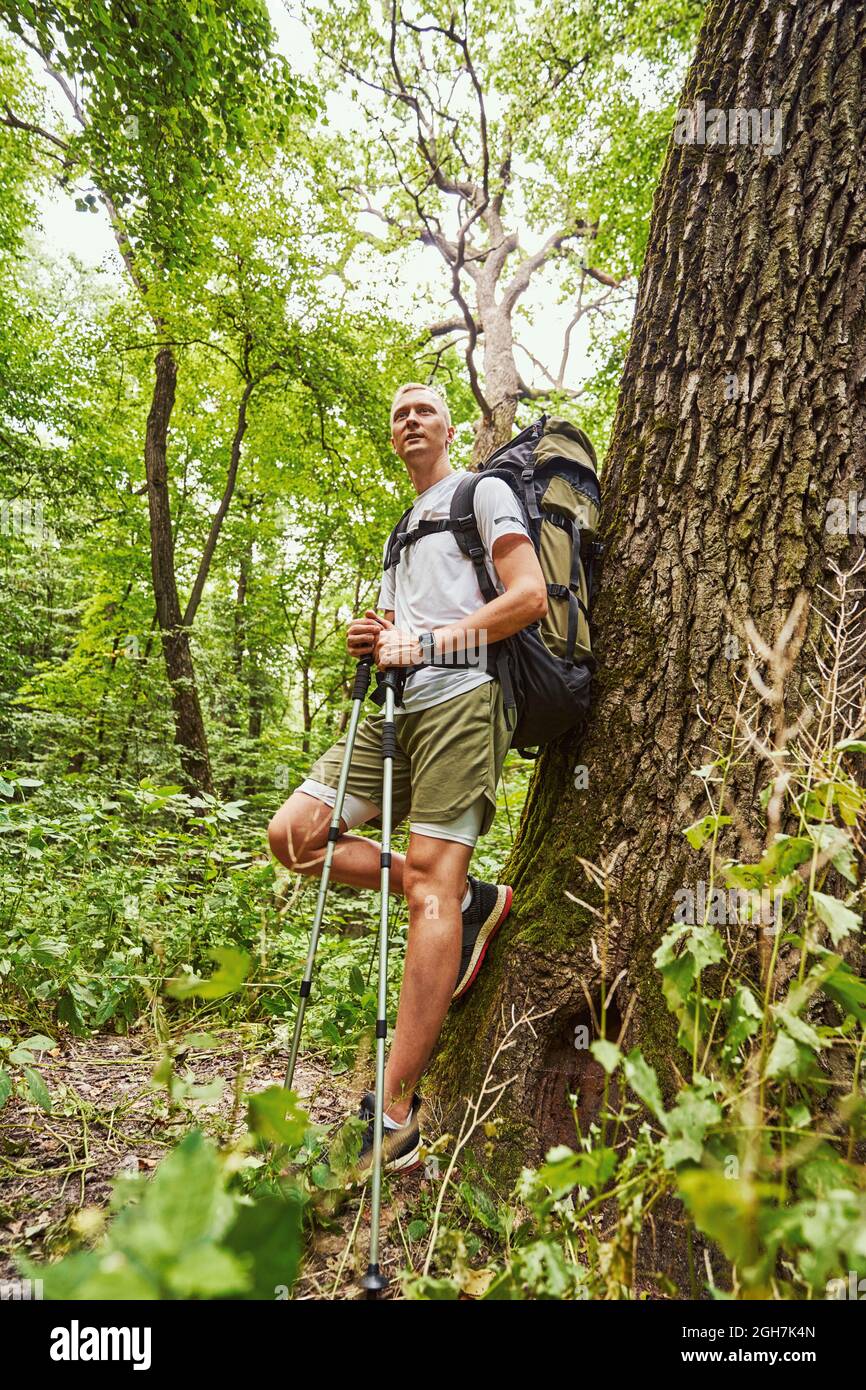 Relaxed young man hiking alone in nature Stock Photo - Alamy