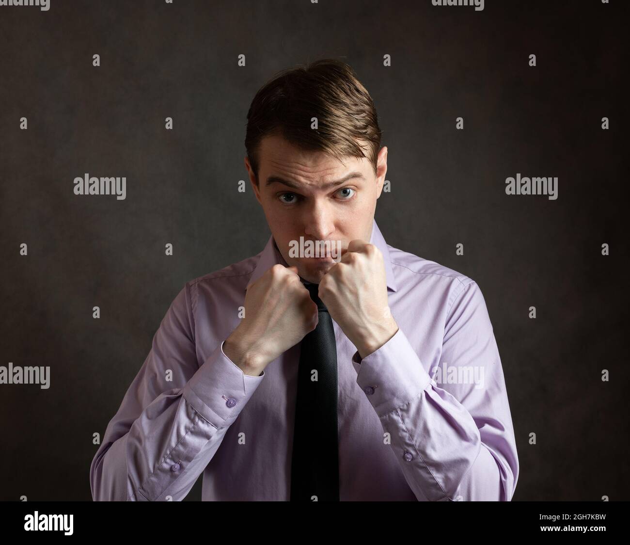 Portrait of angry young man on dark background Stock Photo - Alamy