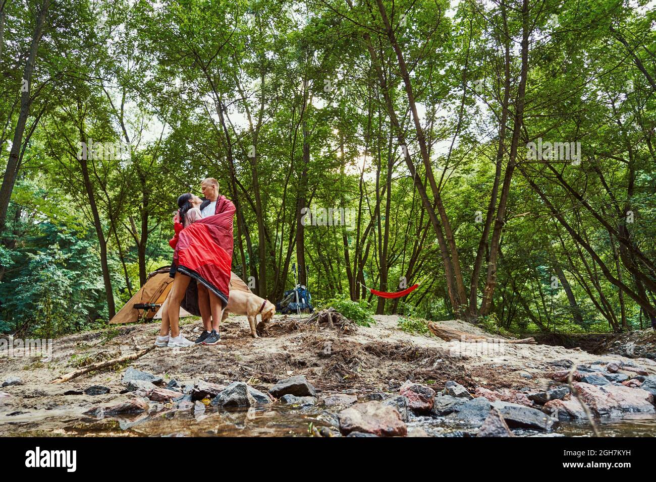 Happy young couple in love going camping Stock Photo - Alamy
