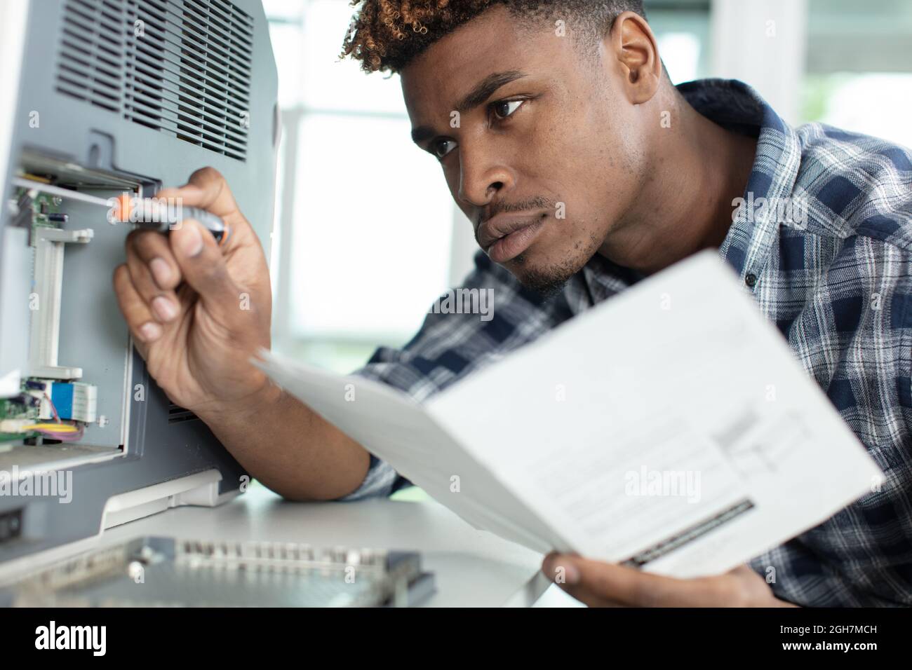handyman fixing the office printer Stock Photo - Alamy