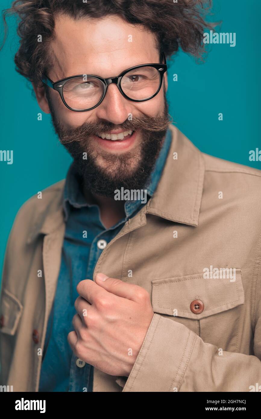 Attractive happy man fixing moustache hi-res stock photography and ...