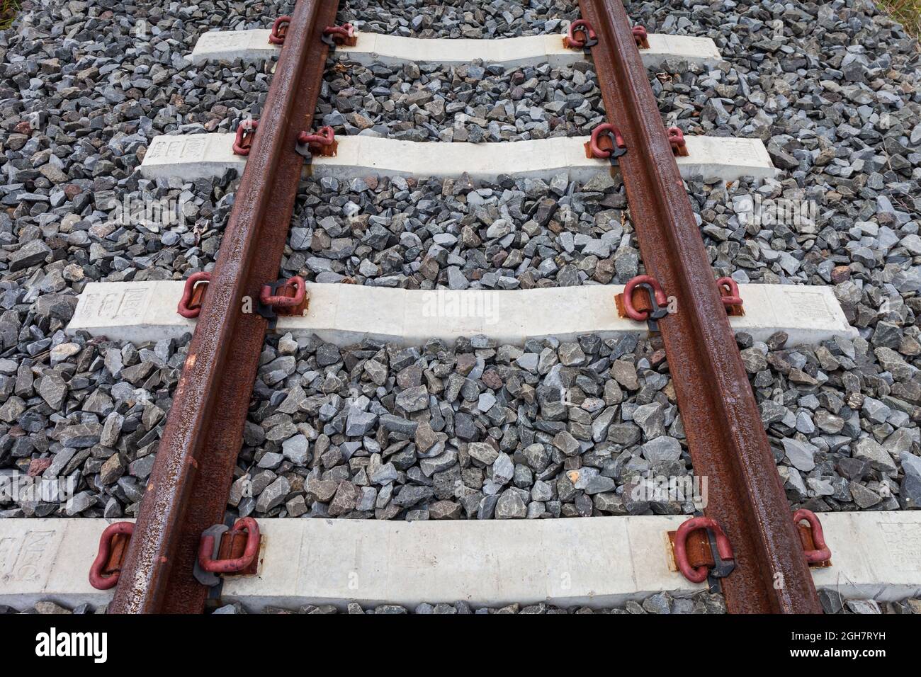railroad tracks with rust on rock background Stock Photo - Alamy