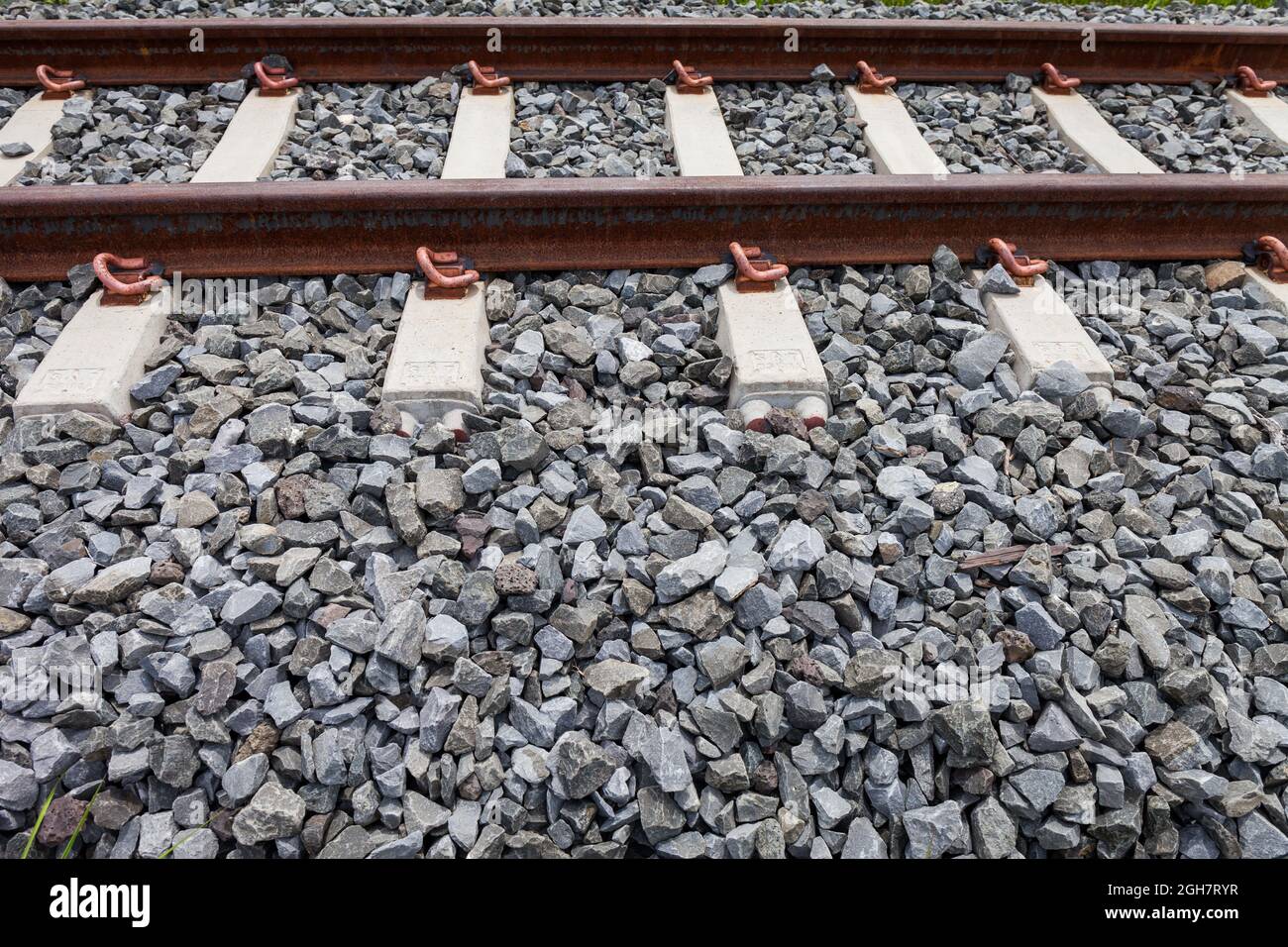 railroad tracks with rust on rock background Stock Photo - Alamy