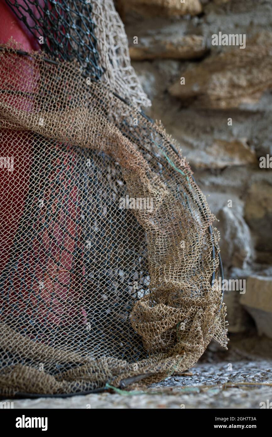 Old fishing net near the wall of an old house Stock Photo - Alamy