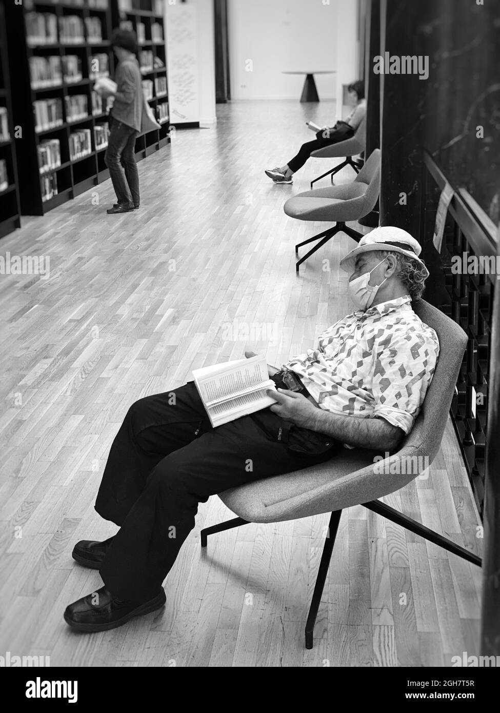 Sleeping man in the library with an open book on the lap Stock Photo ...