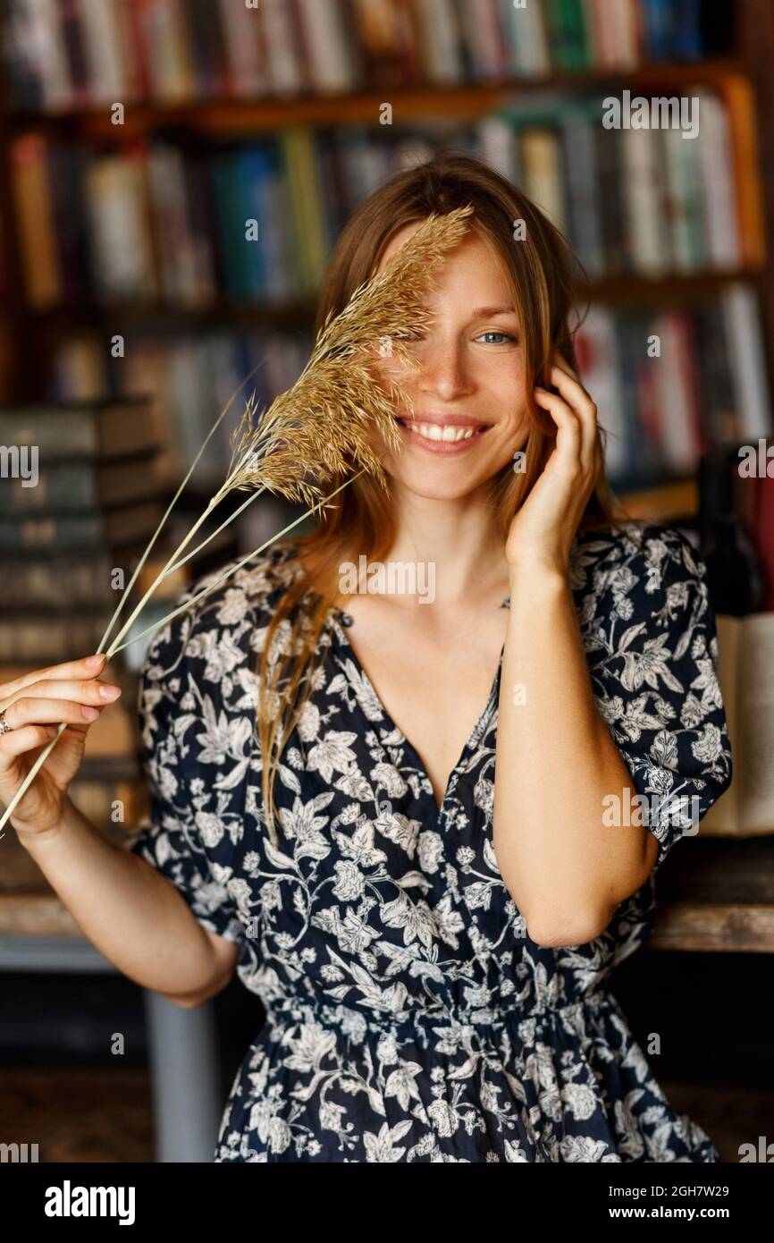 Pretty smiling joyfully female with fair hair, dressed casually ...