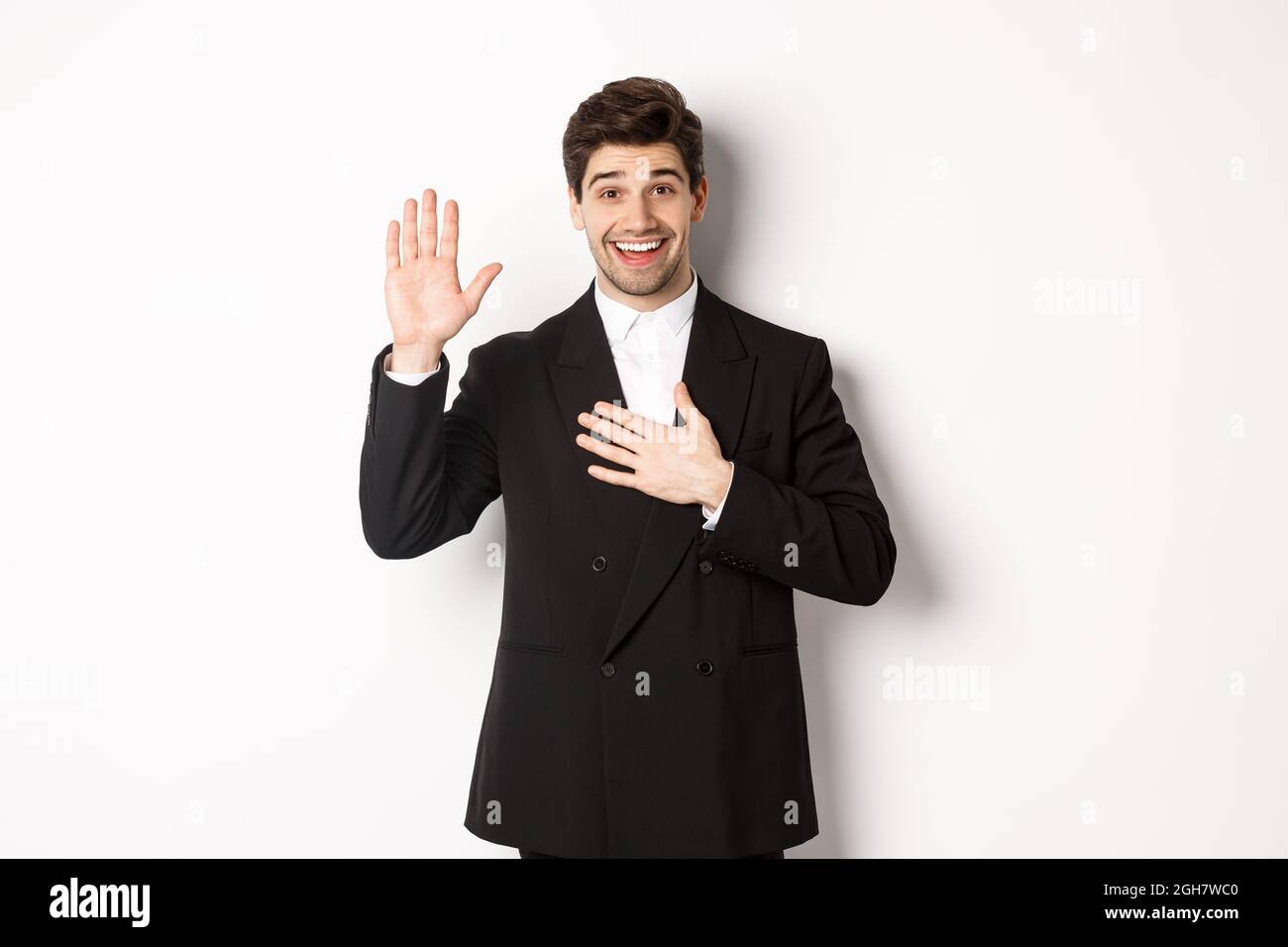 Image of handsome smiling guy telling the truth, raising on arm to ...