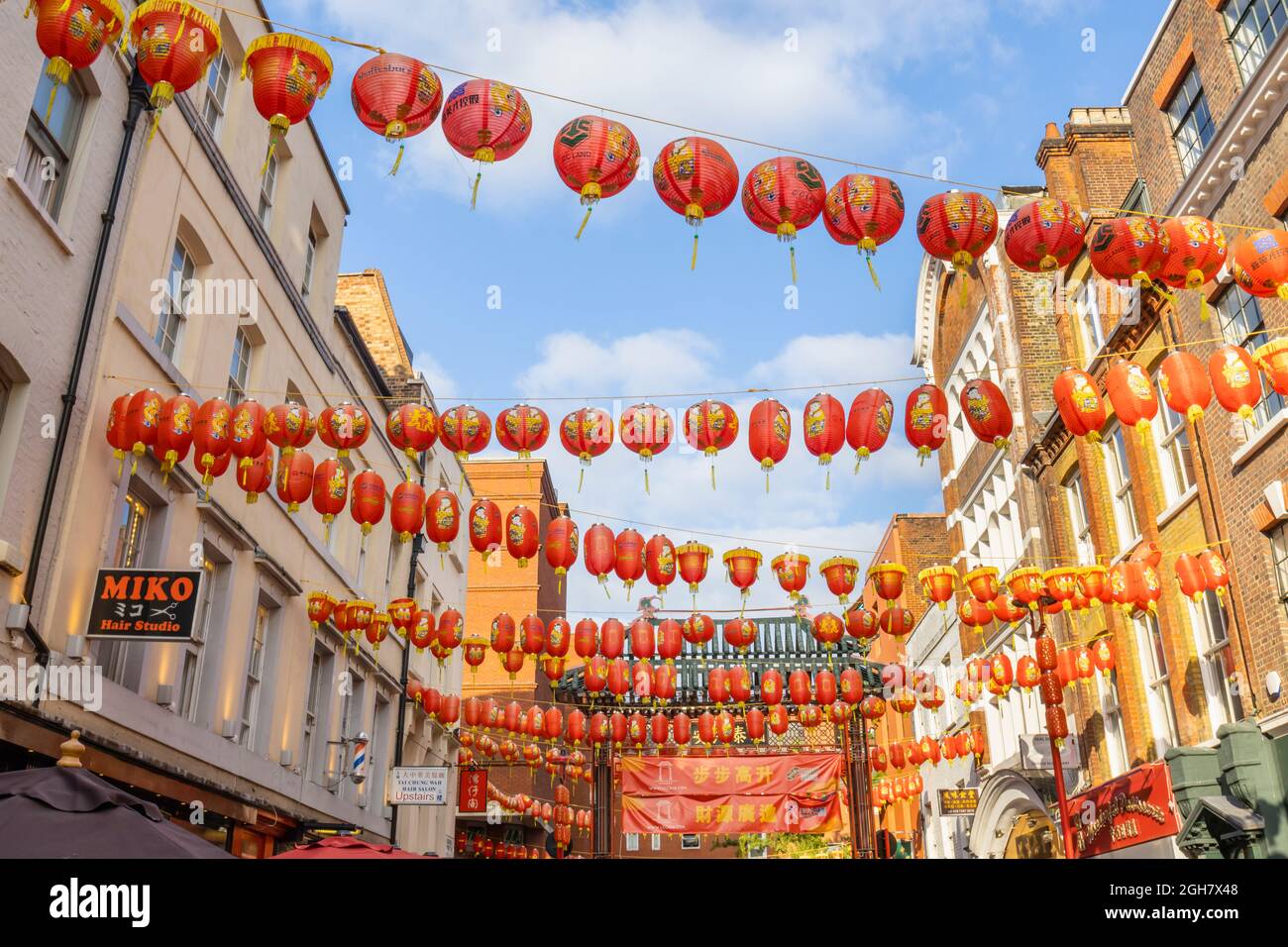 Colourful red and gold Chinese lanterns strung across Gerrard Street in Chinatown in the West ...
