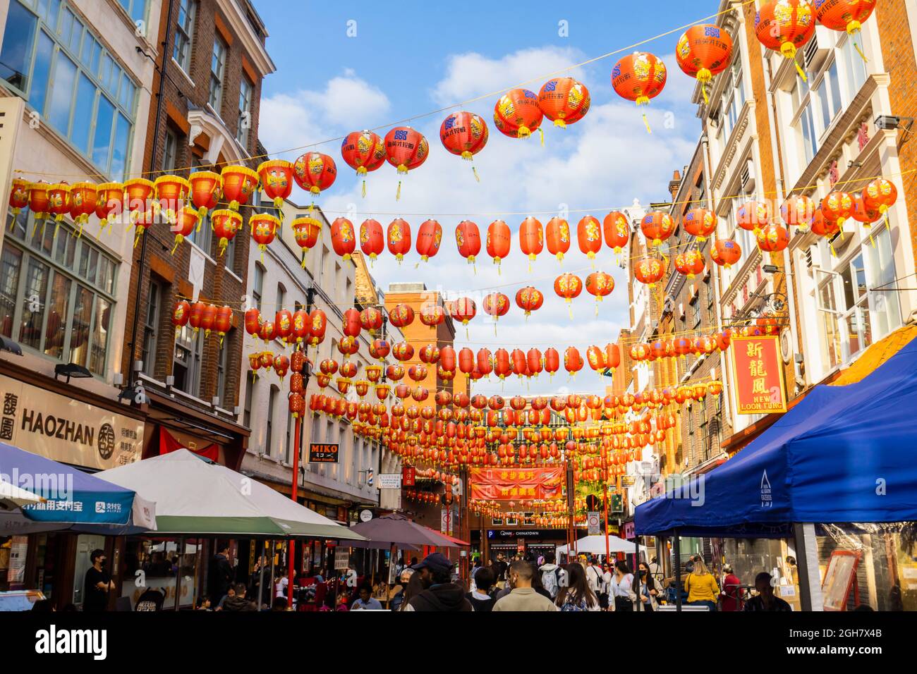 Colourful red and gold Chinese lanterns strung across Gerrard Street in Chinatown in the West ...
