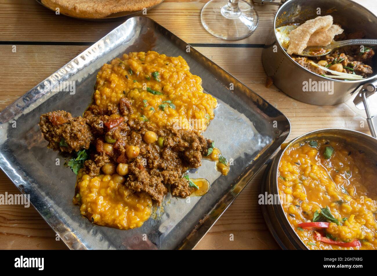 Close up of Indian meal at Mowgli -- lamb curry, temple dahl, and puri ...