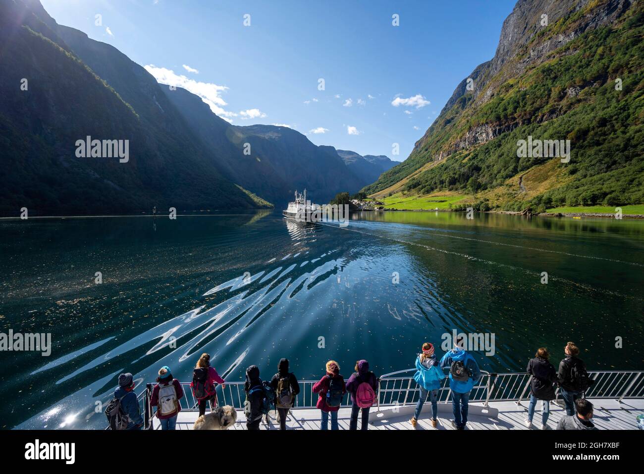 Tourists on the deck of the electric catamaran The Future Of The Fjords ...