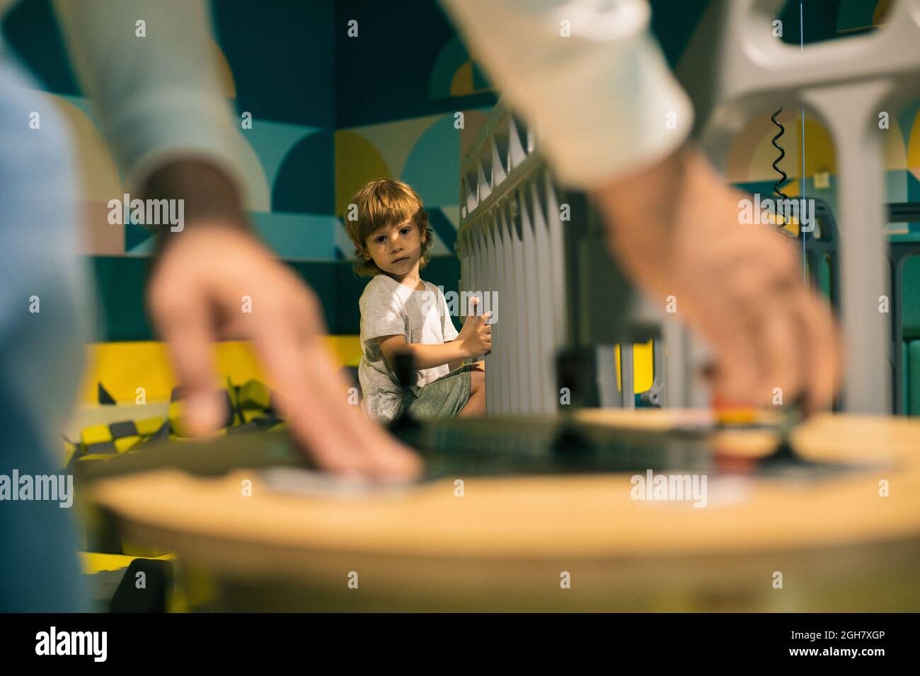 Little boy looks at how his father starts mechanism in children's ...