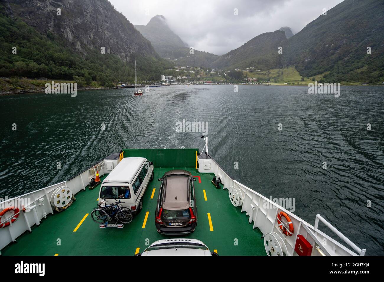 Cars on the deck of a ferry running between the towns of Geiranger and ...