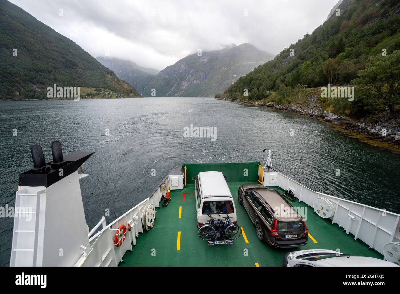 Cars on the deck of a ferry running between the towns of Geiranger and ...