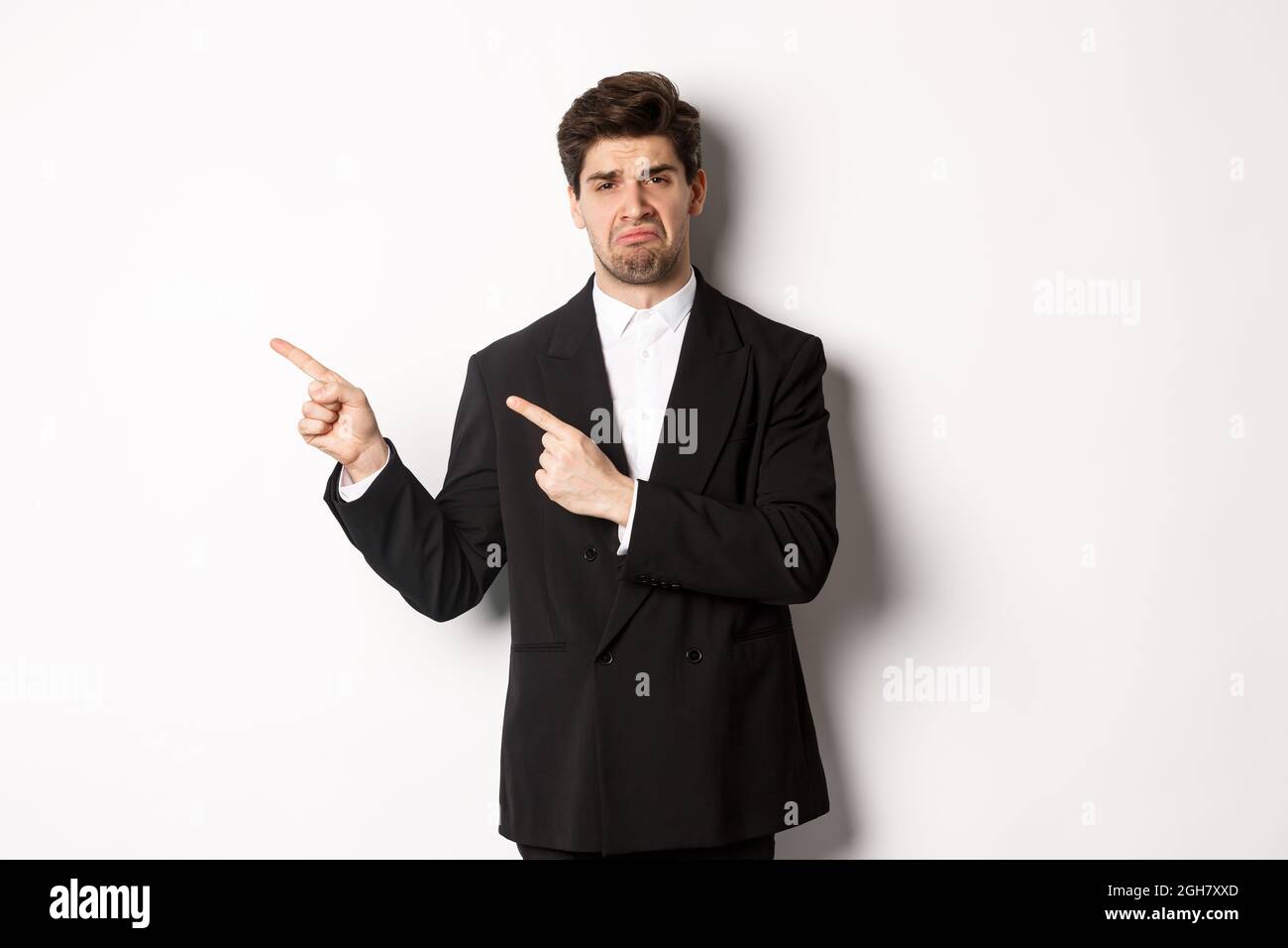 Portrait of disappointed and sad handsome businessman in suit ...