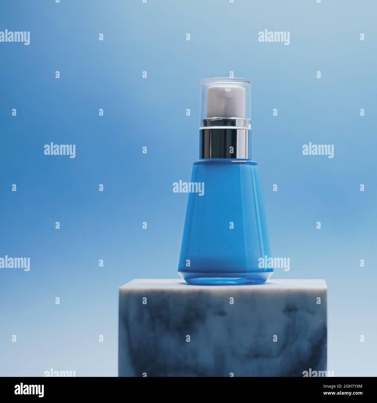 Serum bottle on blue background, luxury skincare products, beauty and ...