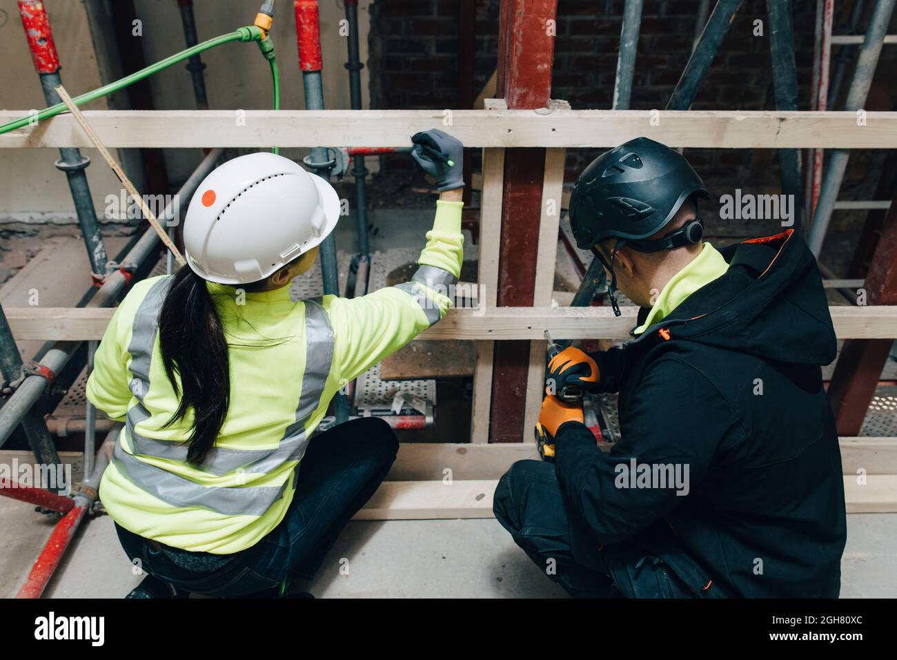 Male and female colleagues working together at construction site Stock ...