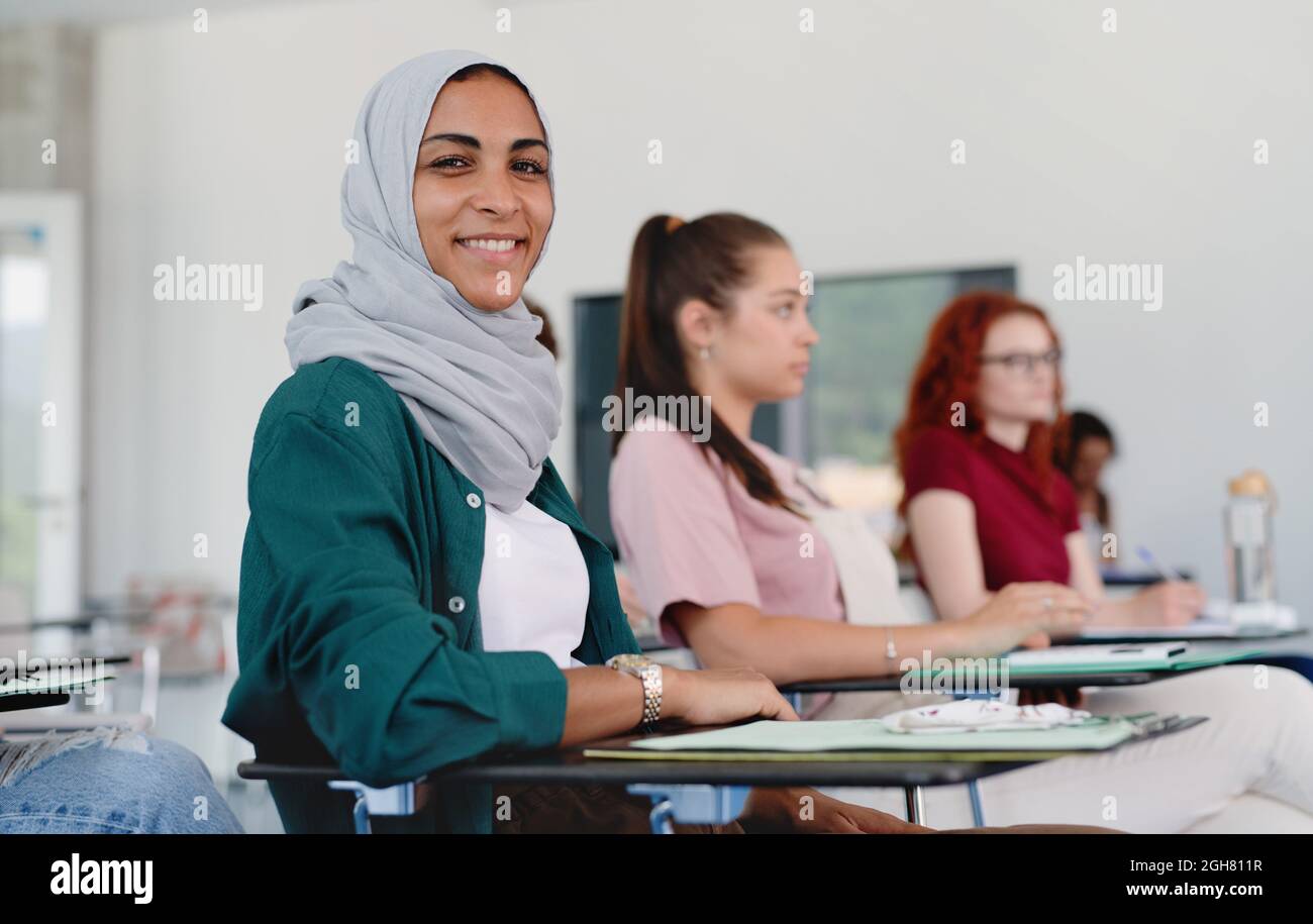 Portrait of islamic university student sitting in classroom indoors ...