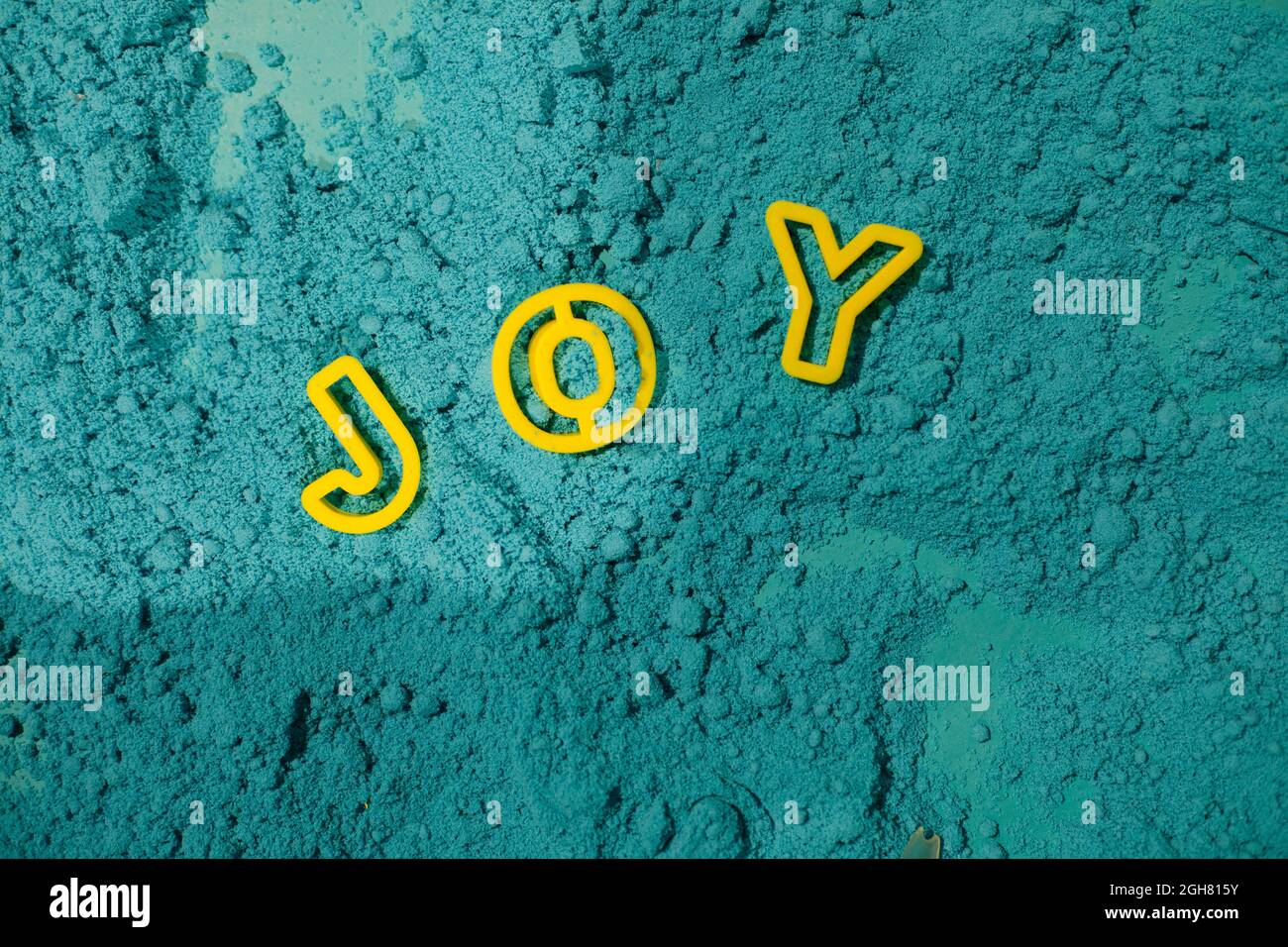 The Word JOY Laid Out On Turquoise Kinetic Sand Children s Creativity