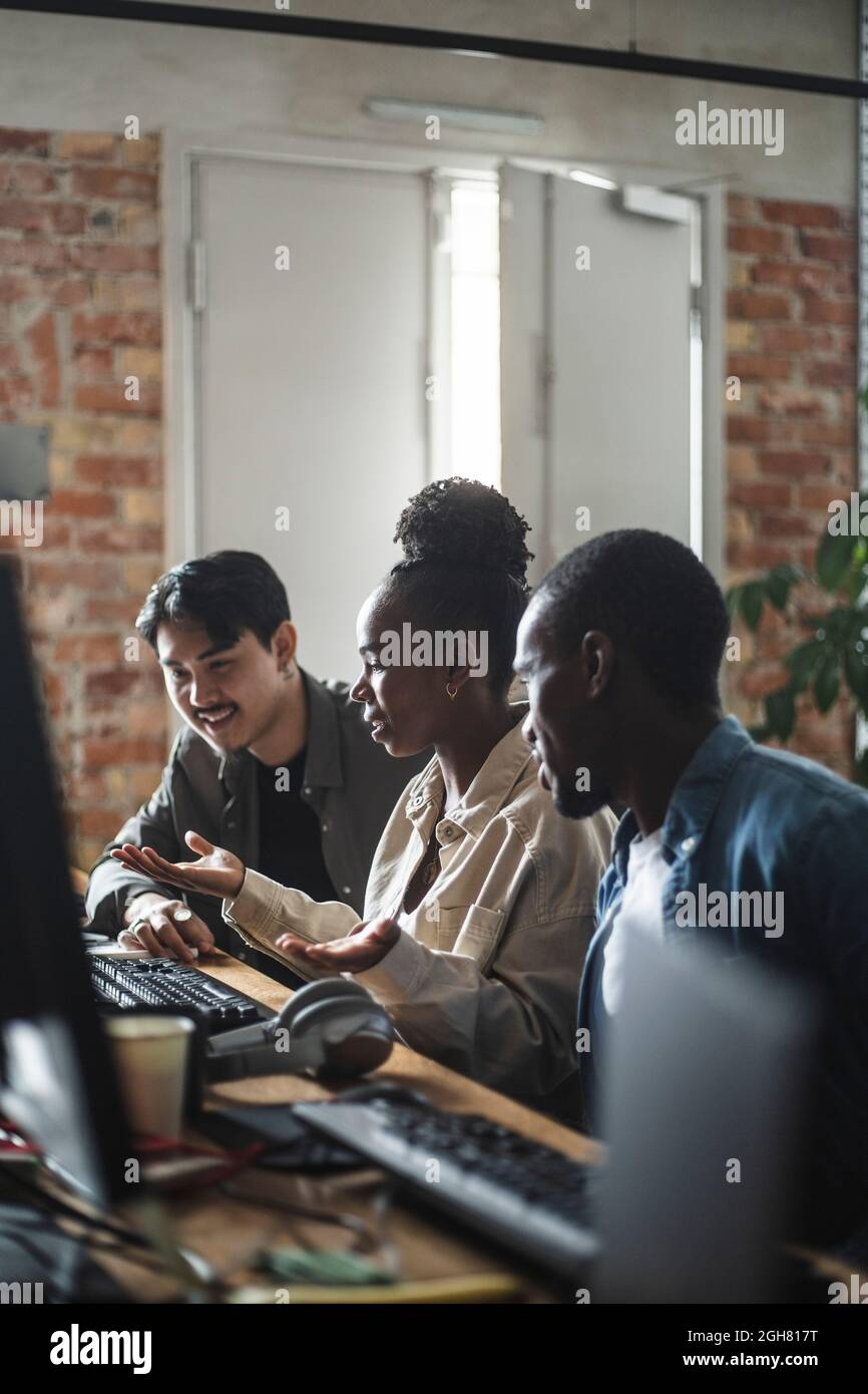 Computer programmer gesturing discussing hi-res stock photography and ...