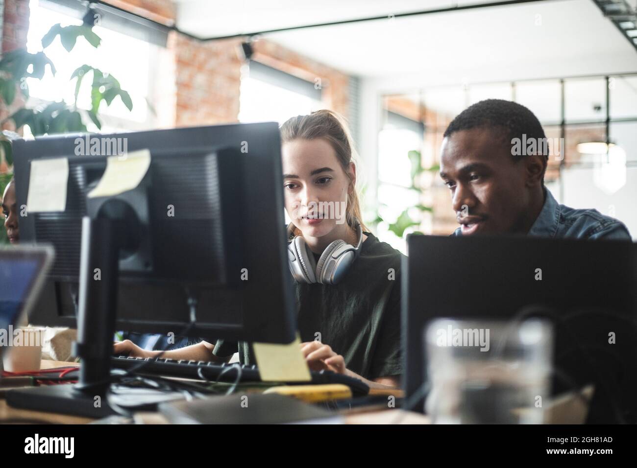 Female and male programmers coding on computer at office Stock Photo ...