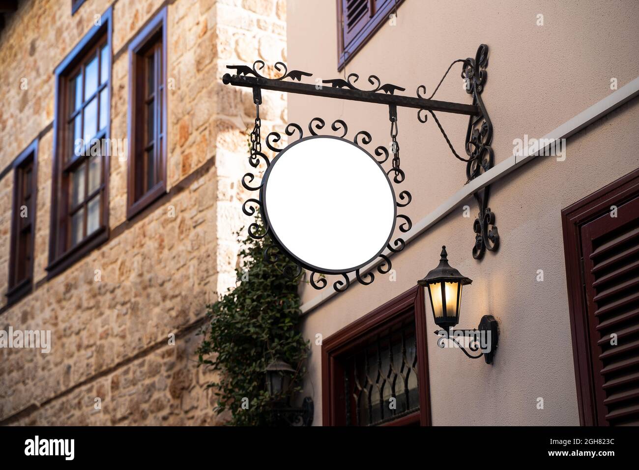 Horizontal front view of empty round signage on a building with ...
