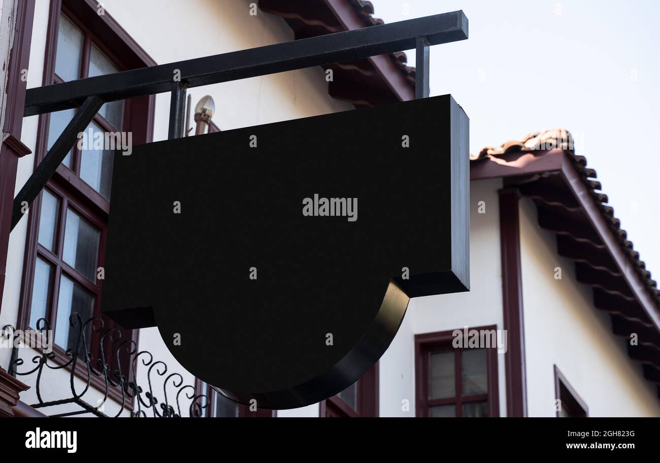 Horizontal front view of empty round black signage on a building with ...