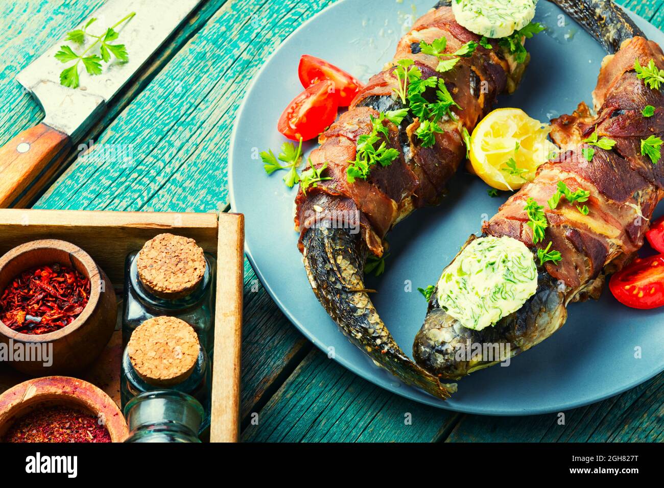 Baked fish wrapped in bacon, fried pelengas Stock Photo - Alamy