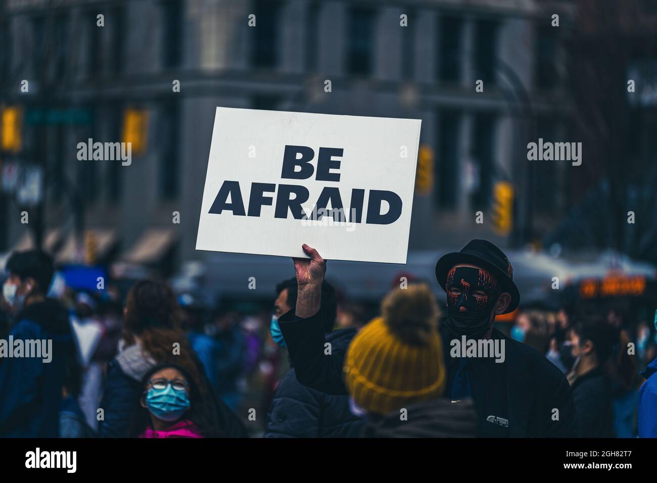 Man holding up the "Be afraid" sign at a stop Asian hate protest in ...