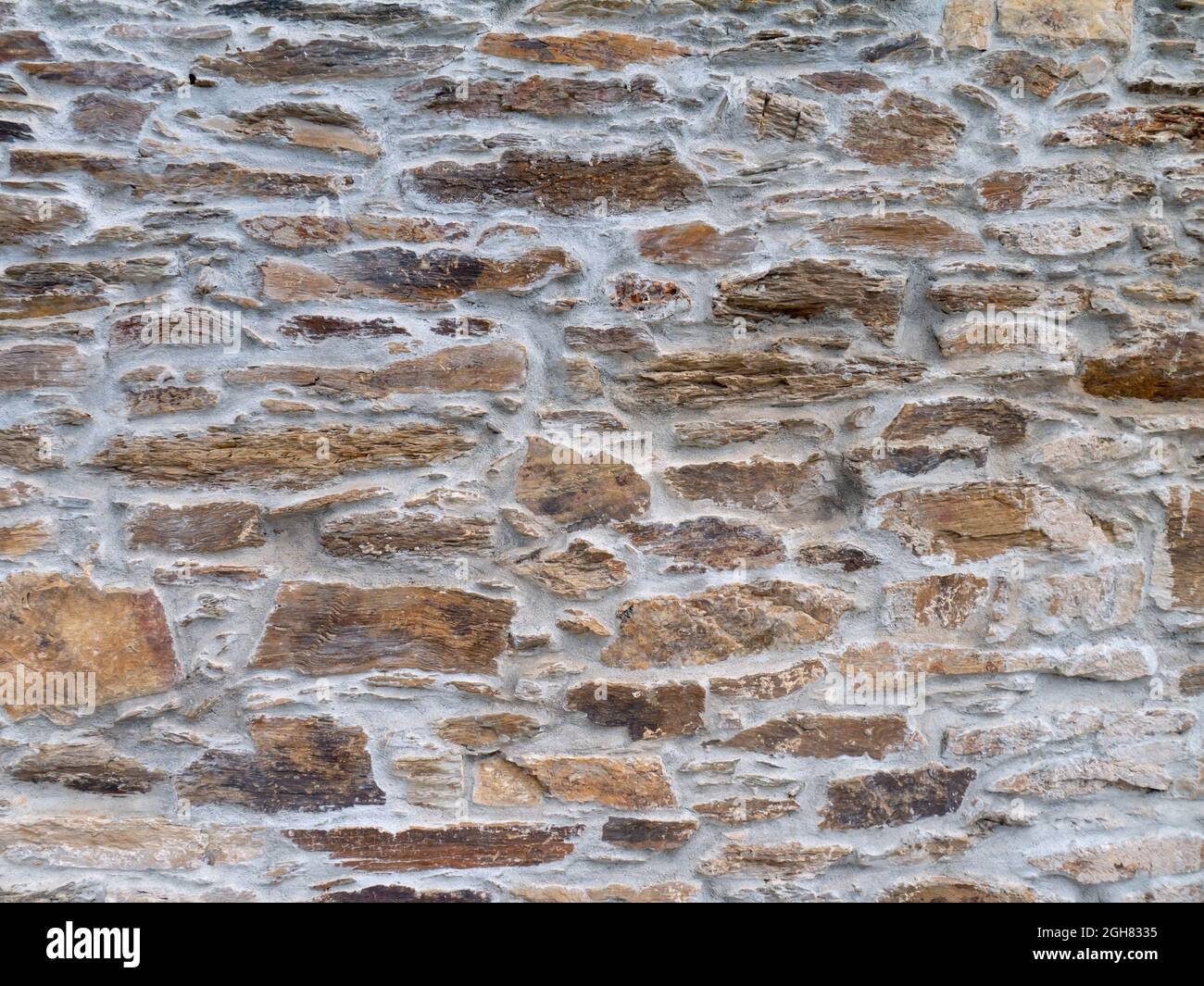 Ancient natural brown stone wall with gray cement background Stock ...