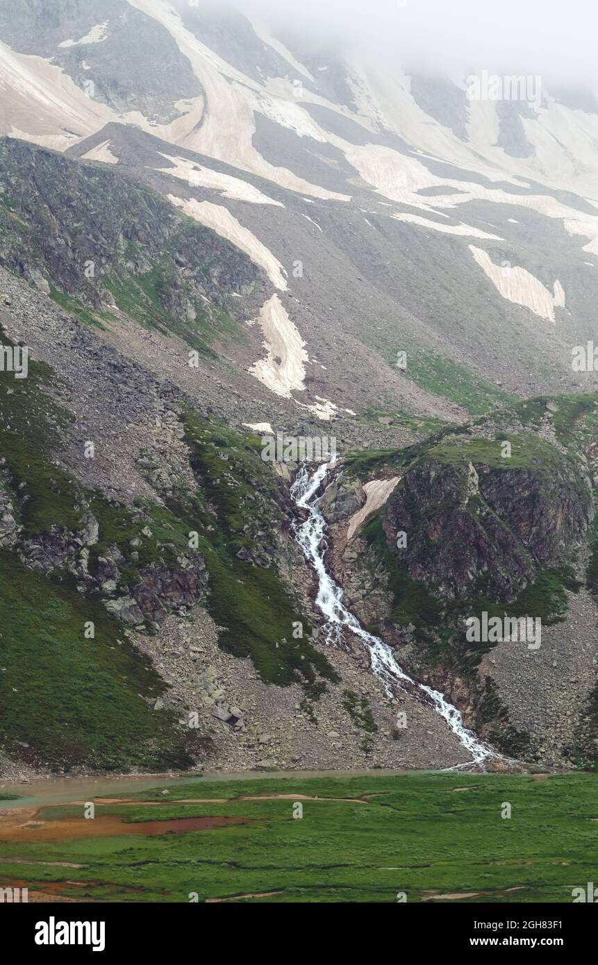 Snow melts in the mountains and flows down to the plain.Melting glacier ...