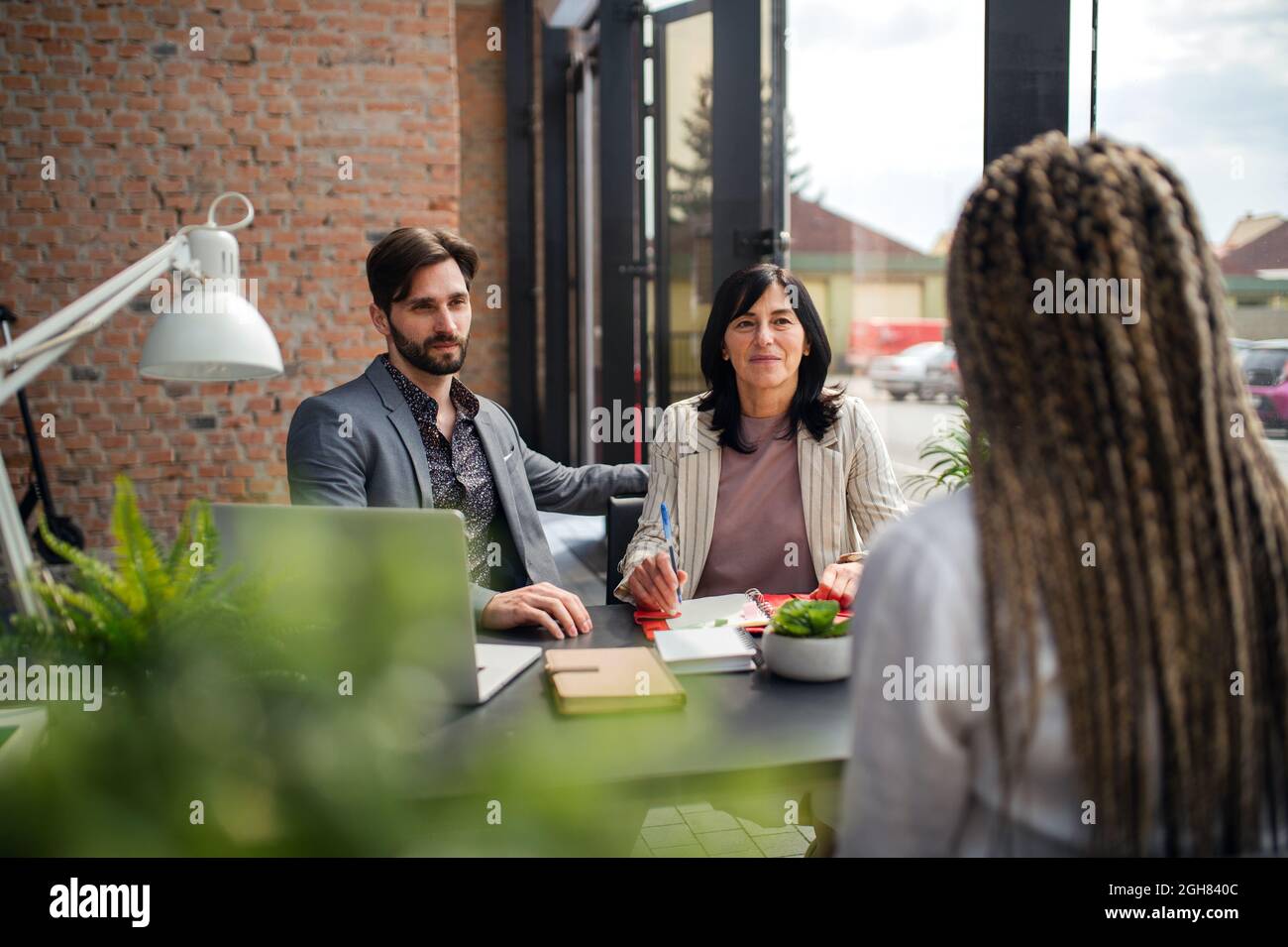 Rear view of young woman having job interview in office, business and ...