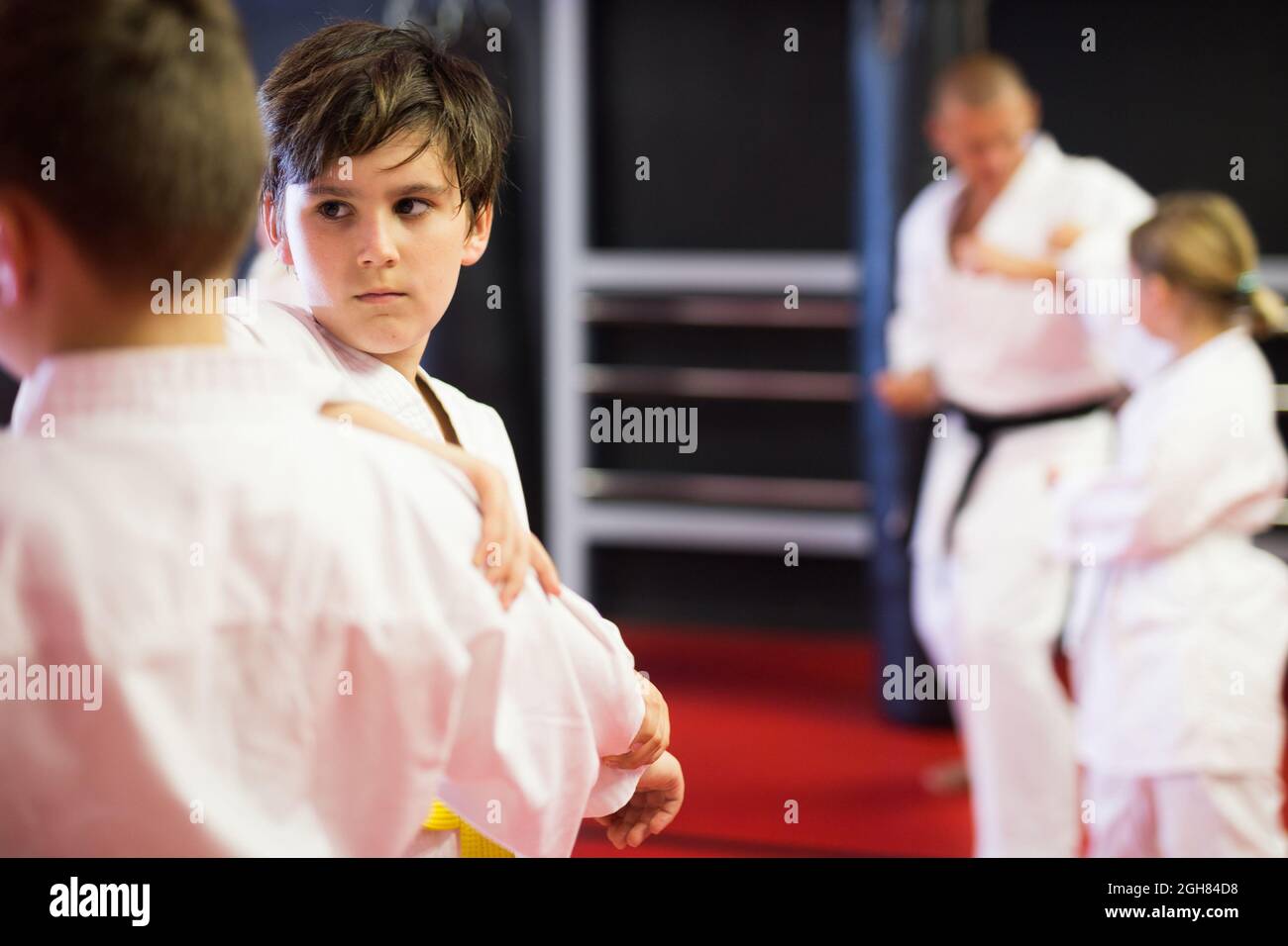 Karate kids in kimono sparring together during their group karate ...