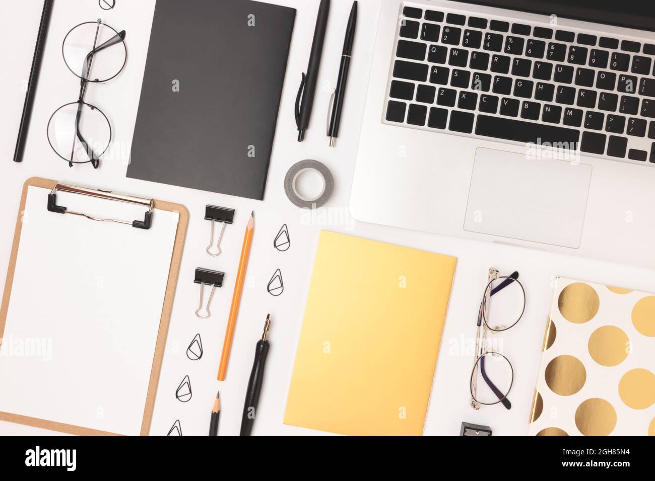 Layout of office supplies and laptop on a white background. Neat ...