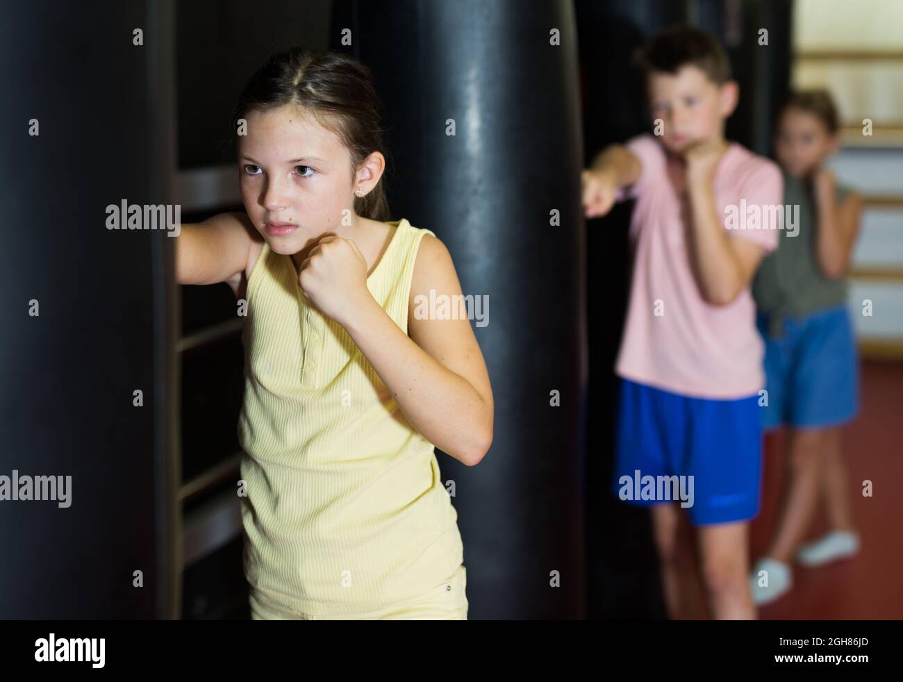 Boys and girls jabbing punch bags during their group training Stock ...