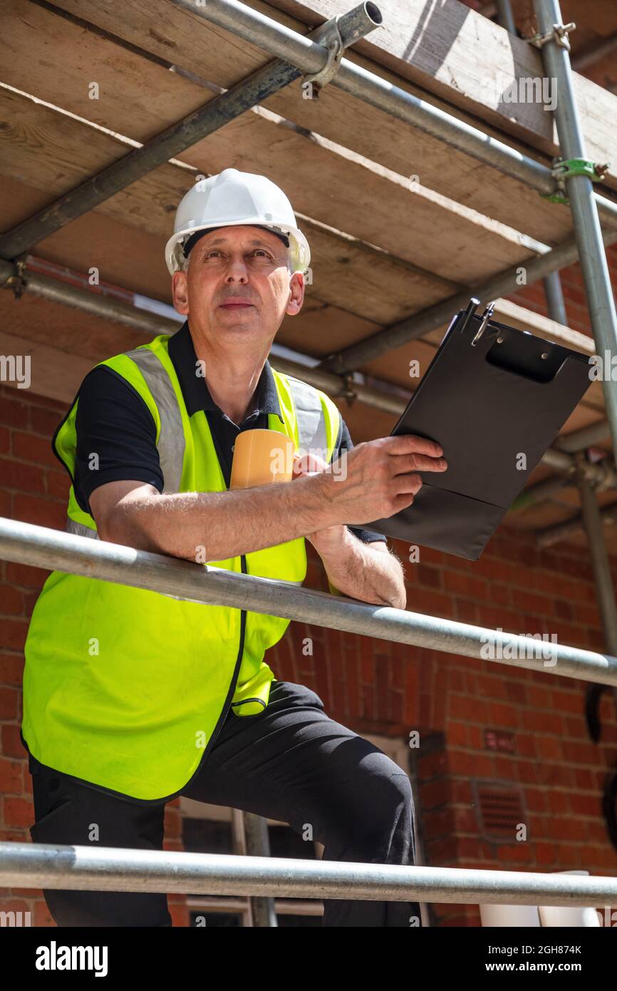 Male man builder foreman, construction worker or architect on site ...