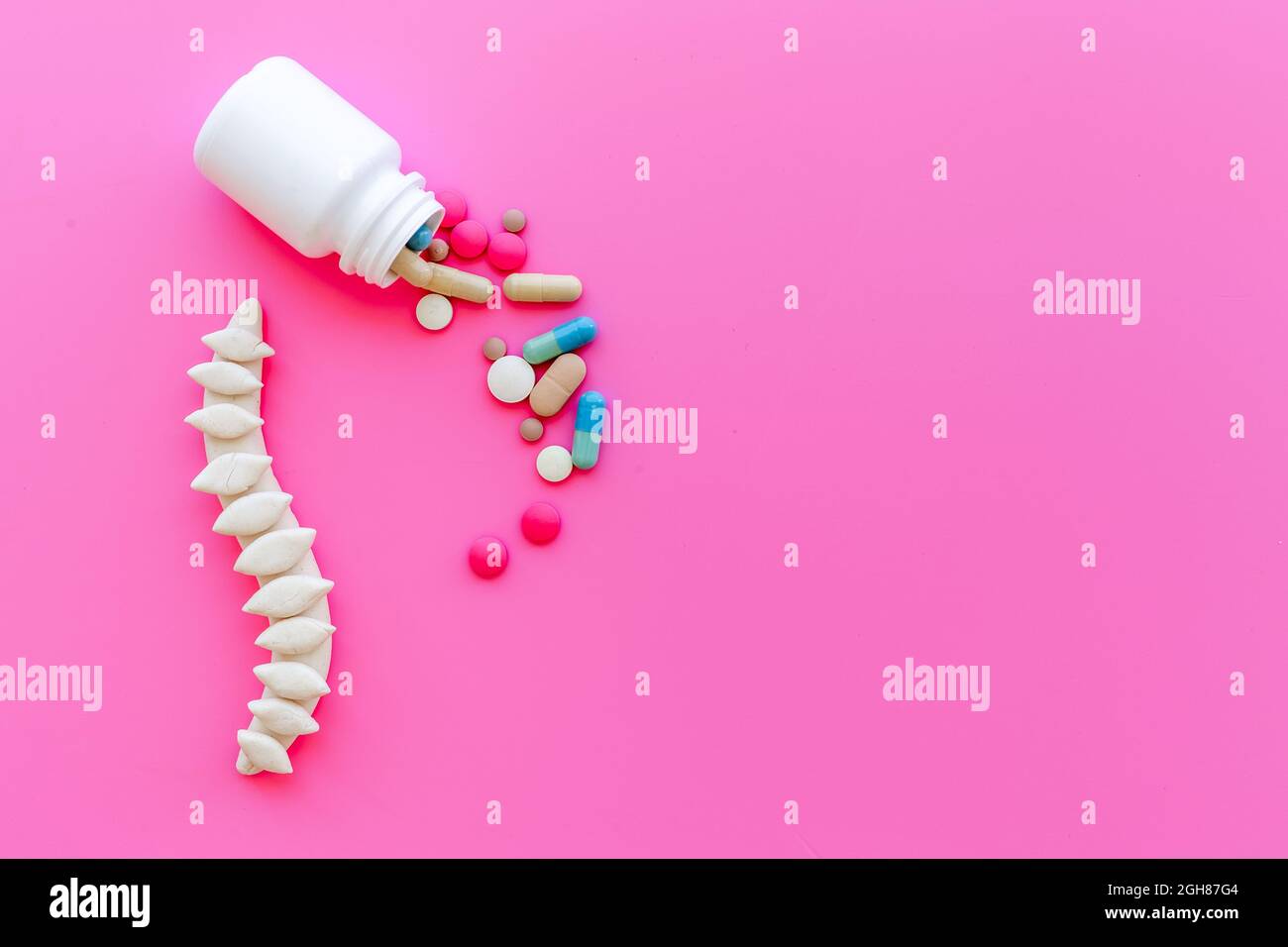 Anatomical spine skeleton with medical pills. Spinal diseases treatment ...