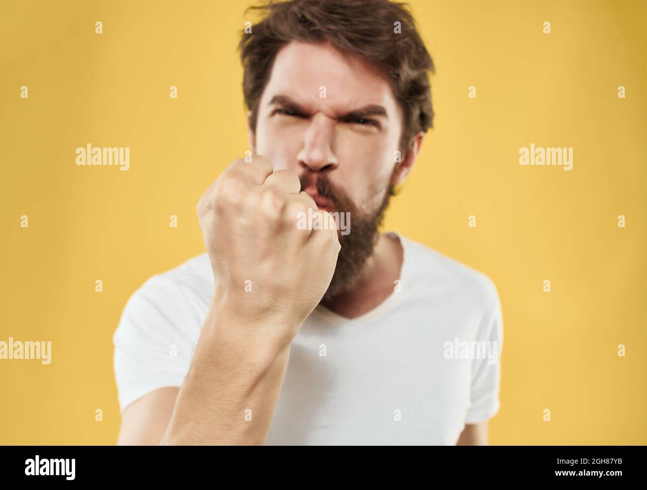 Man in a white t-shirt hand gestures anger Studio Stock Photo - Alamy